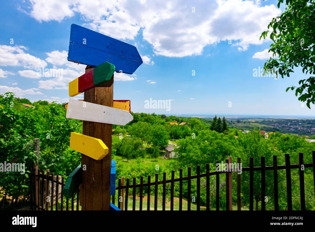 Wooden colorful arrow shape signs, points the way to the different ...