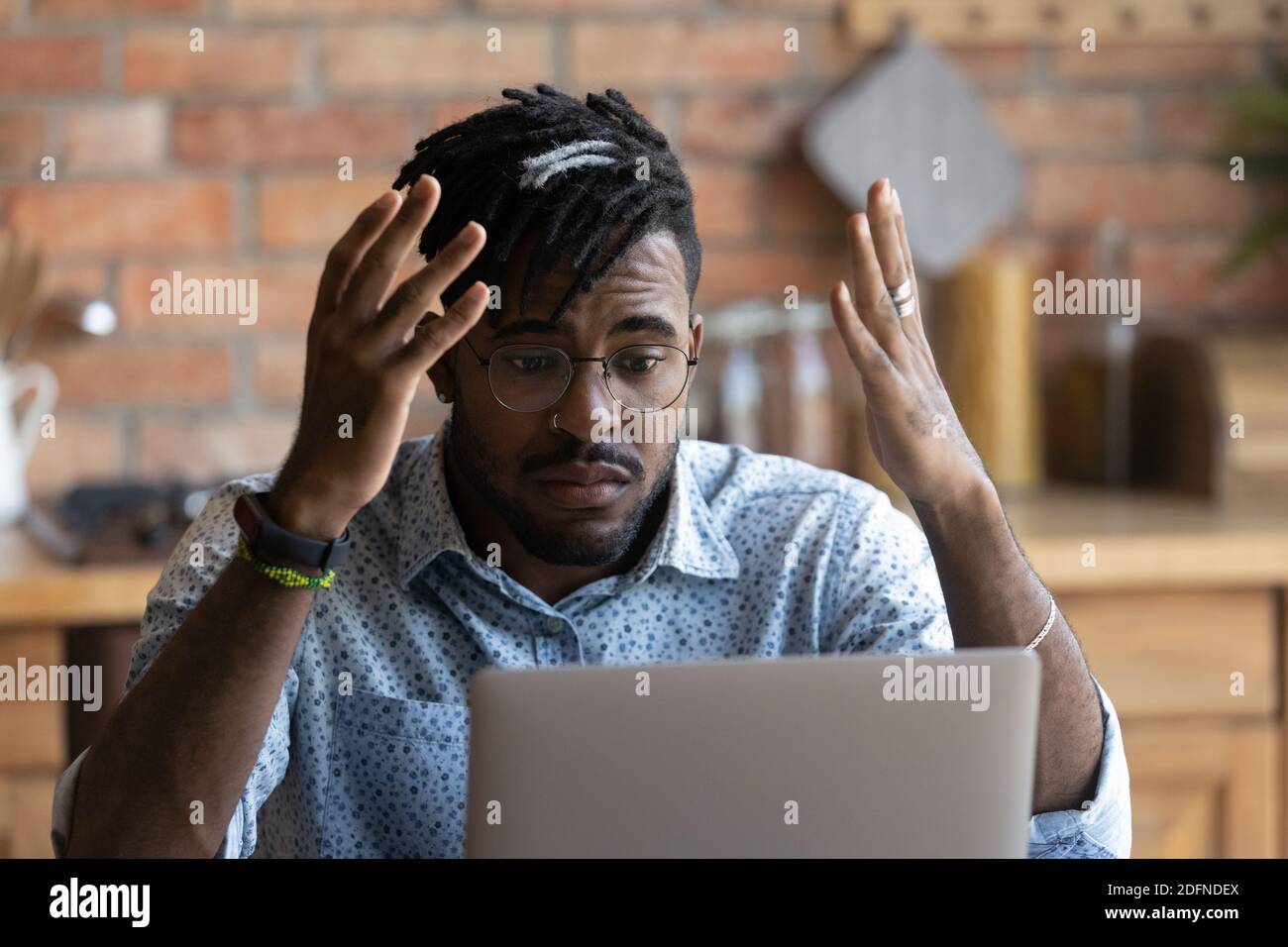 Confused young african american man reading email with bad news Stock ...