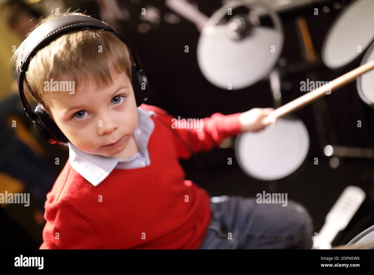 Boy learning to play drums in music class Stock Photo - Alamy