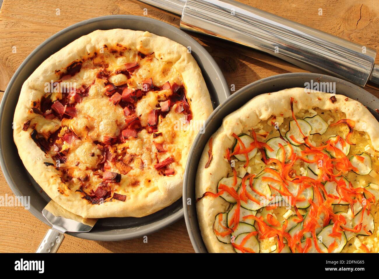 two different pizzas with cheese, ham and one vegetarian Stock Photo ...