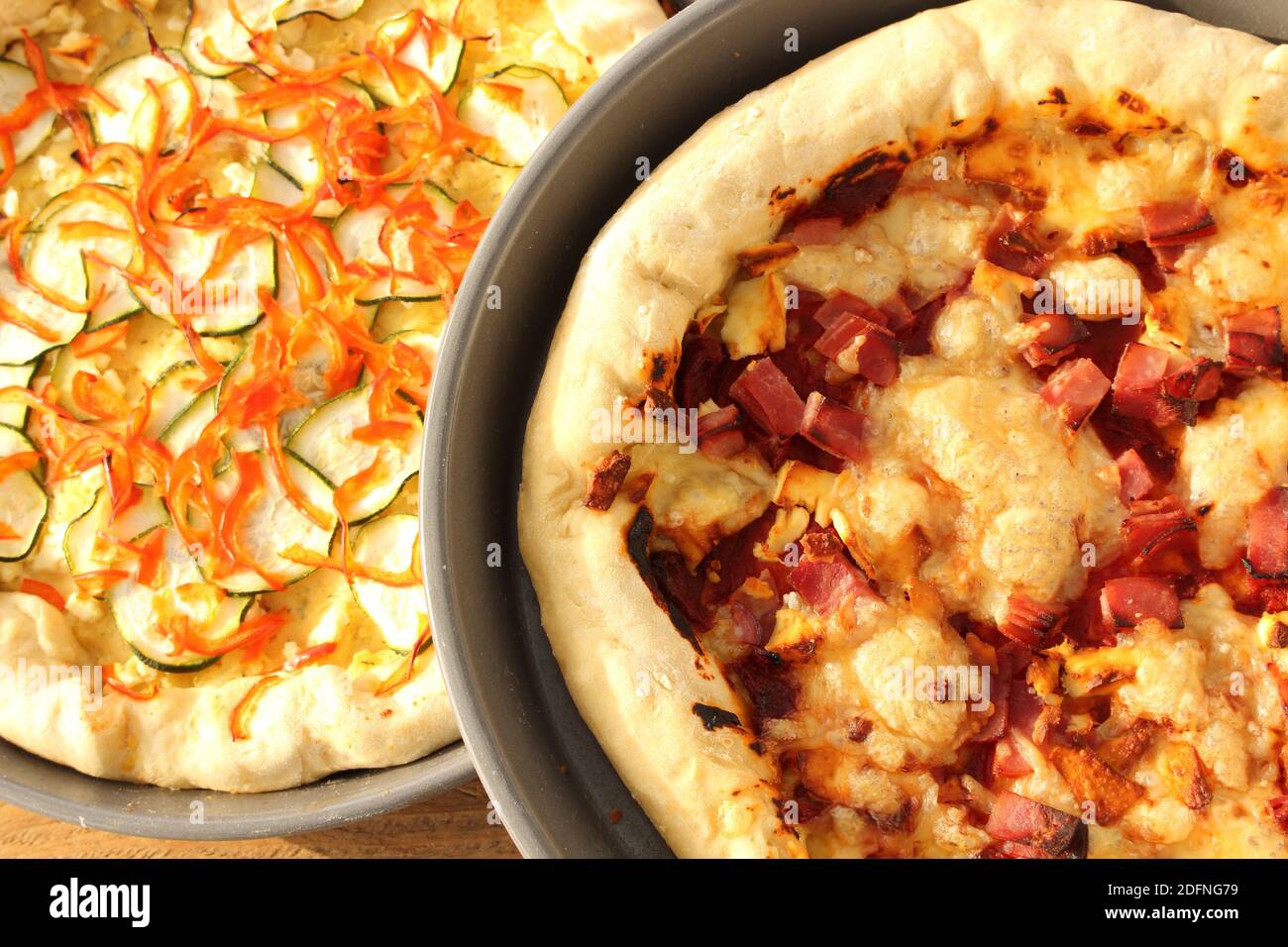 two different pizzas with cheese, ham and one vegetarian Stock Photo ...