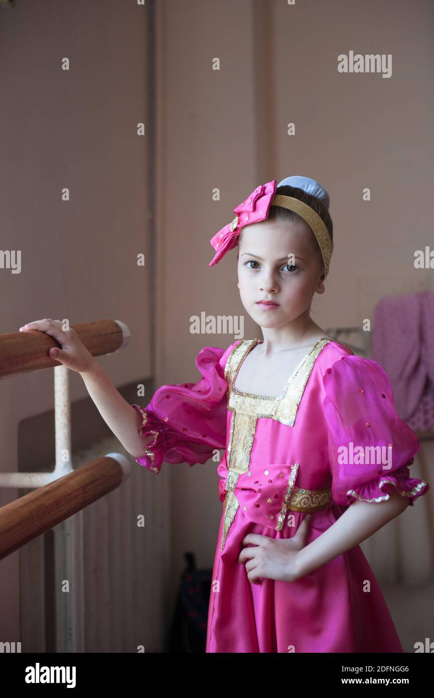 beautiful little girl in traditional costume barre exercise in ballet ...