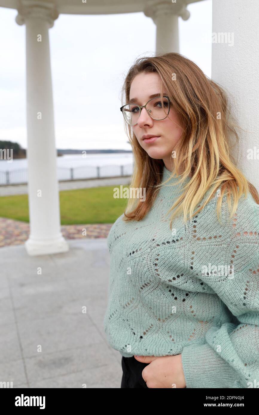 Girl posing near white column in autumn Stock Photo - Alamy