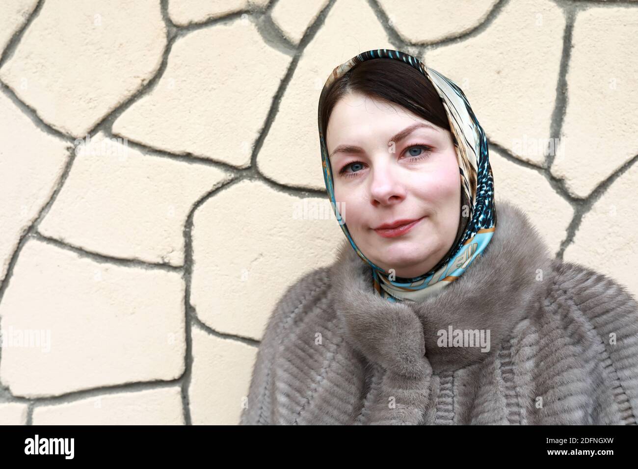 Portrait of woman on background of concrete wall Stock Photo - Alamy