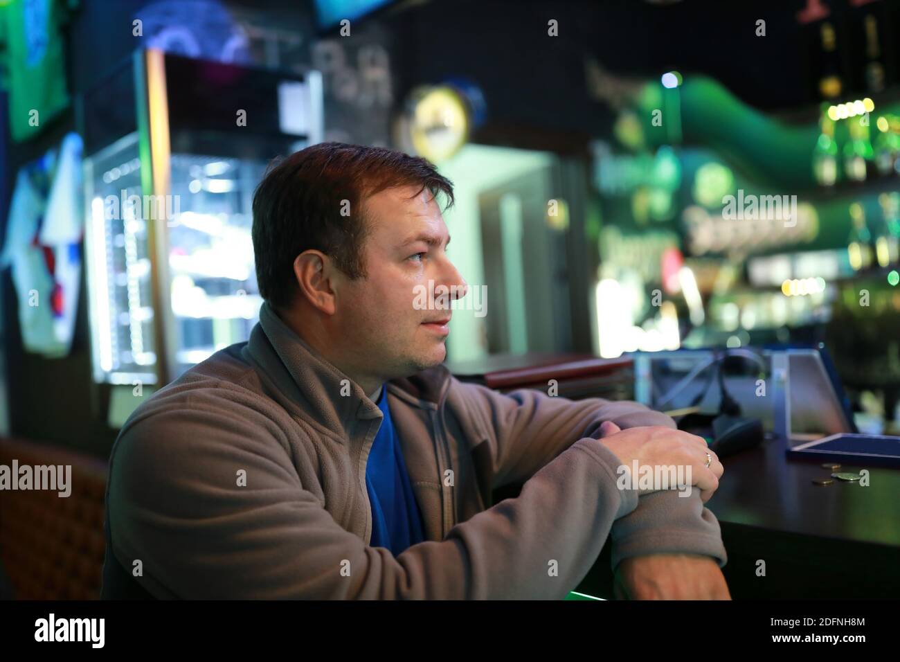 Man sitting at bar in a restaurant Stock Photo - Alamy