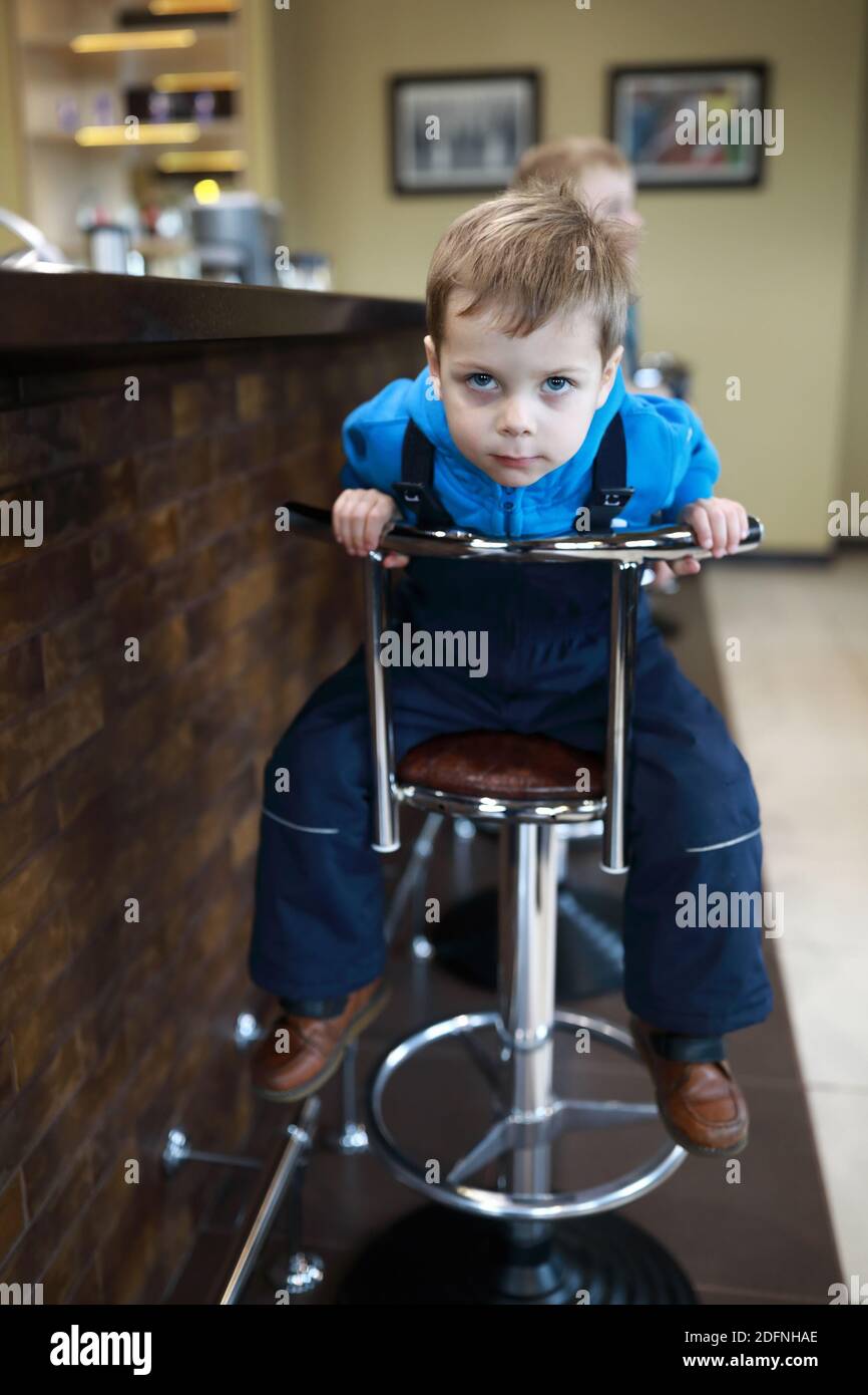 Portrait of boy at bar in restaurant Stock Photo - Alamy