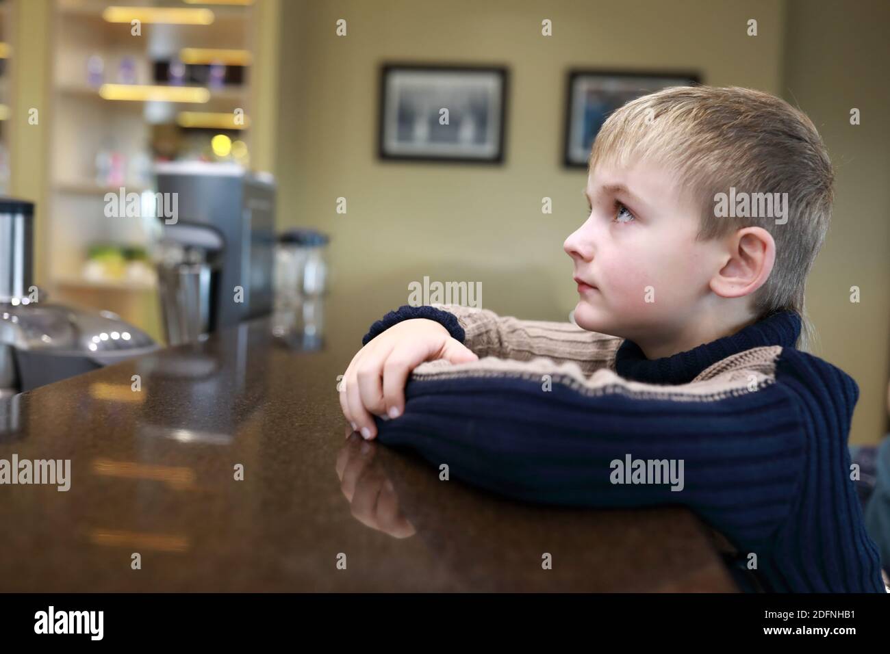 Child sitting at bar in a restaurant Stock Photo - Alamy