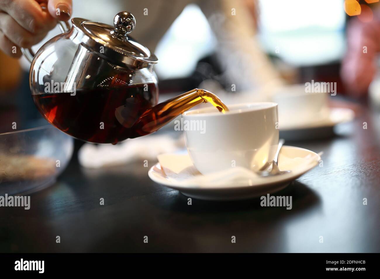 Waitress pouring tea hi-res stock photography and images - Alamy