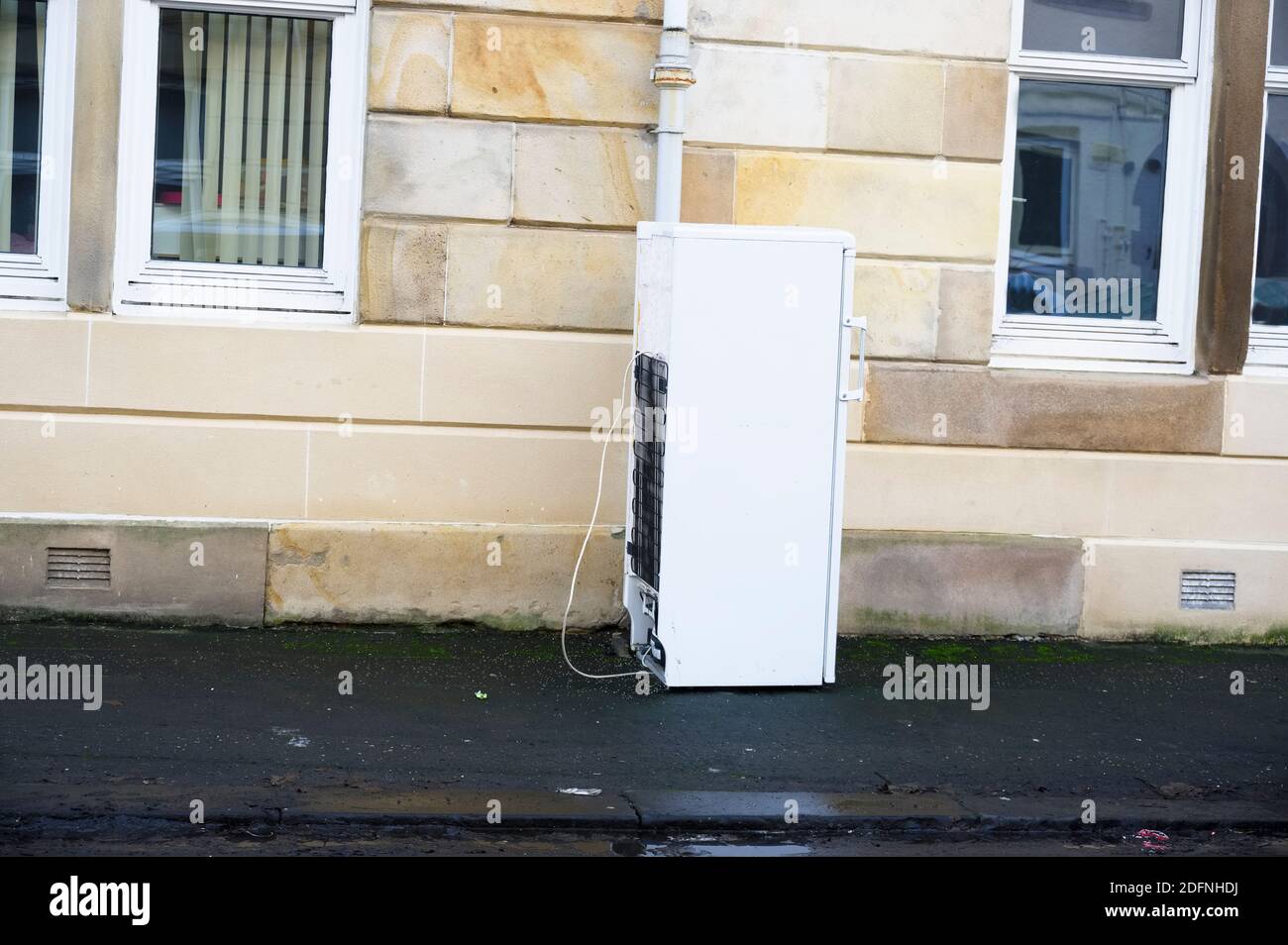 Fridge freezer refrigerator left on street by fly tipping gypsy Stock ...