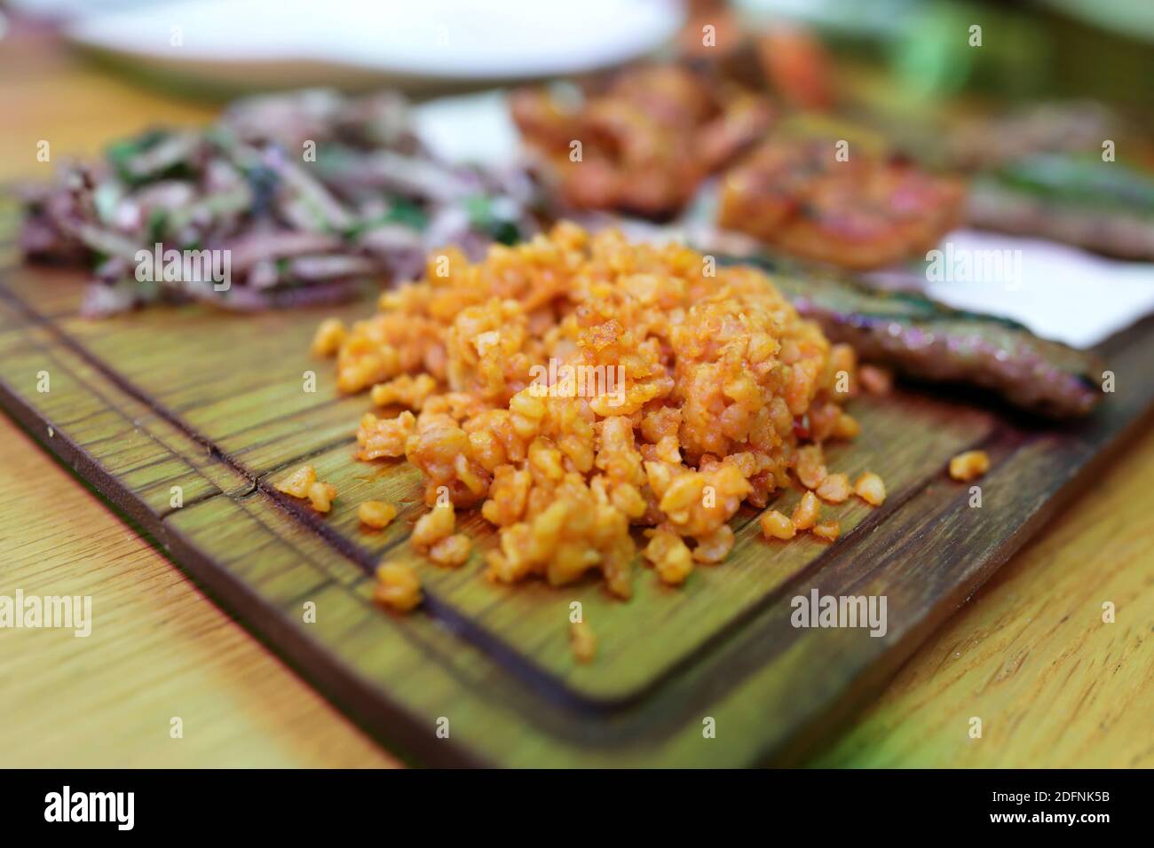 Bulgur dish on wooden board in turkish restaurant Stock Photo - Alamy