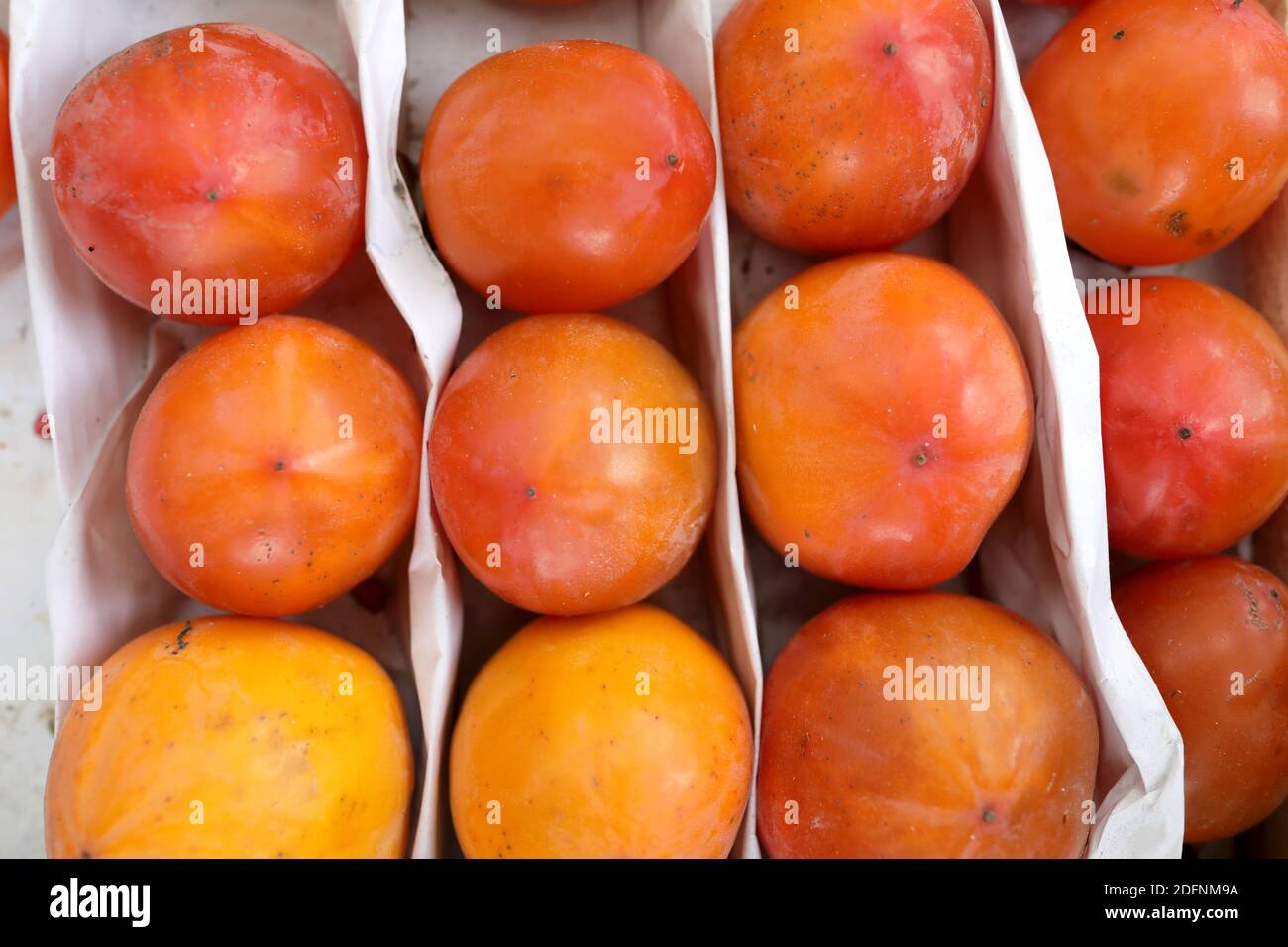 Persimmon fruit in box on the market Stock Photo - Alamy