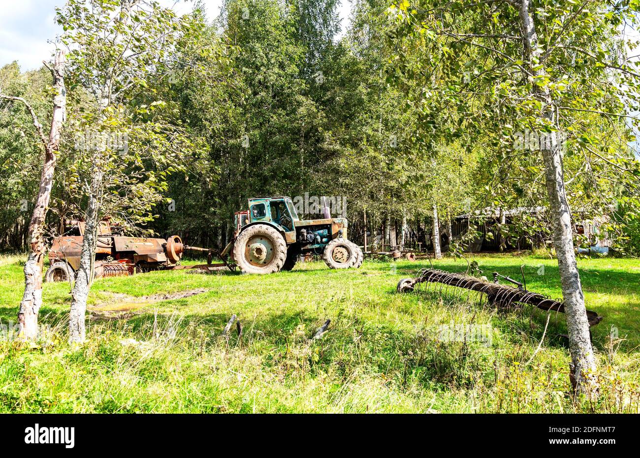 Old dirt agricultural machinery with wheeled tractor and other ...