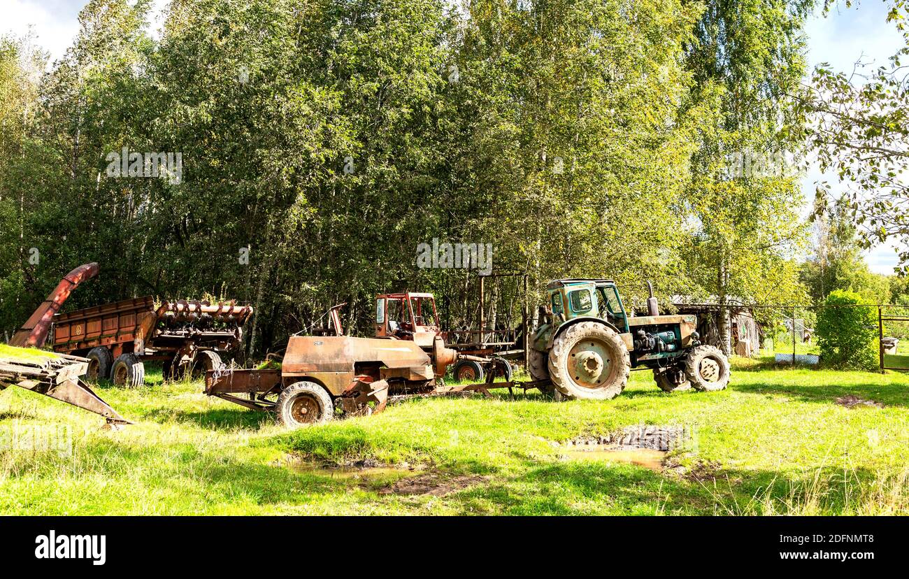 Old dirt agricultural machinery with wheeled tractor and other ...