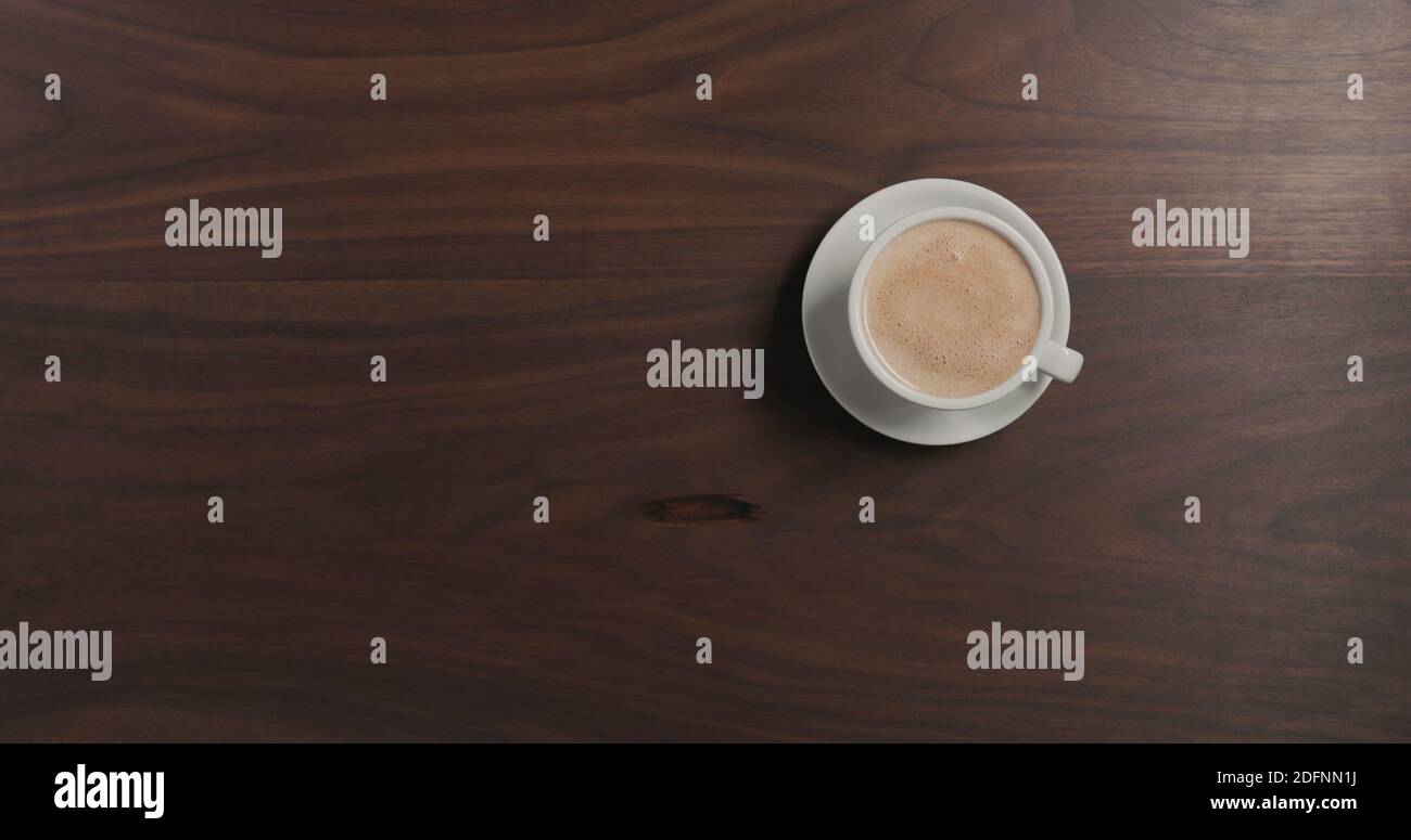 Top view hot chocolate in white cup on walnut wood table wide photo ...
