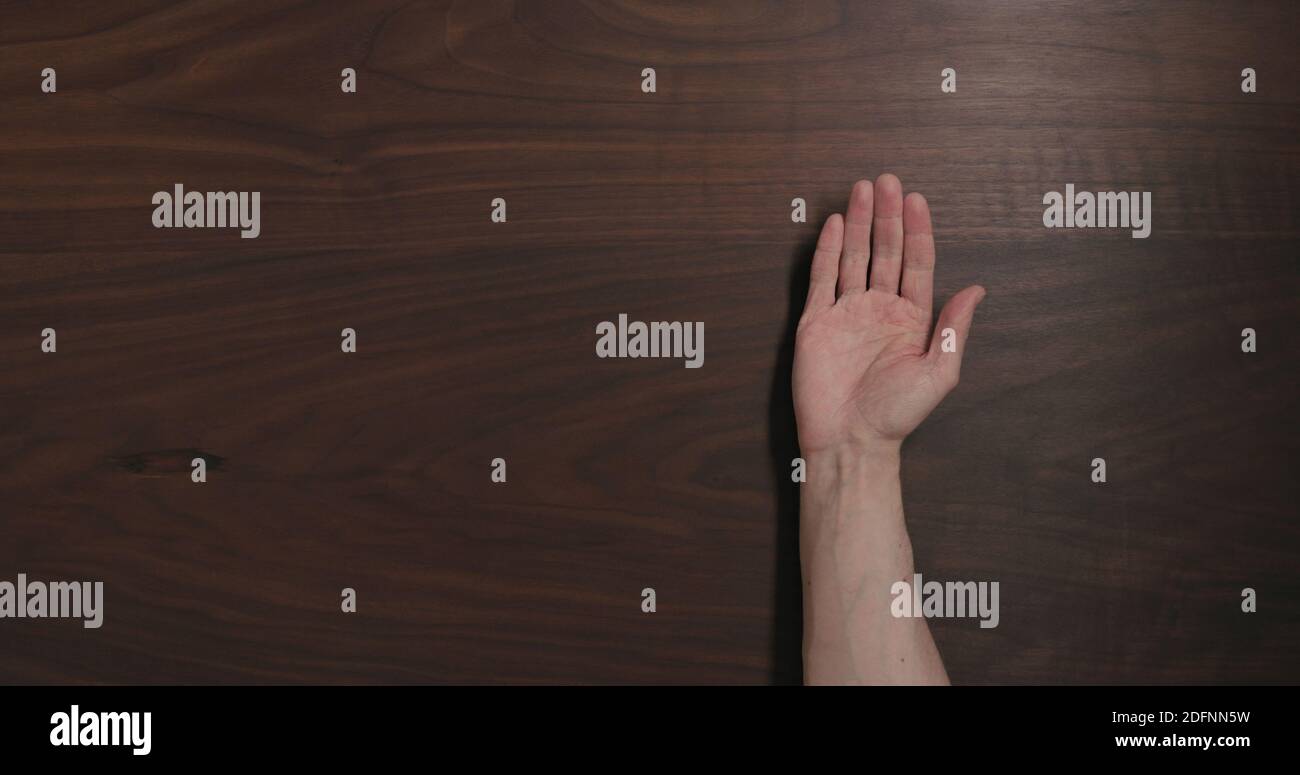 Top view man hand offer gesture black walnut table with copy space ...