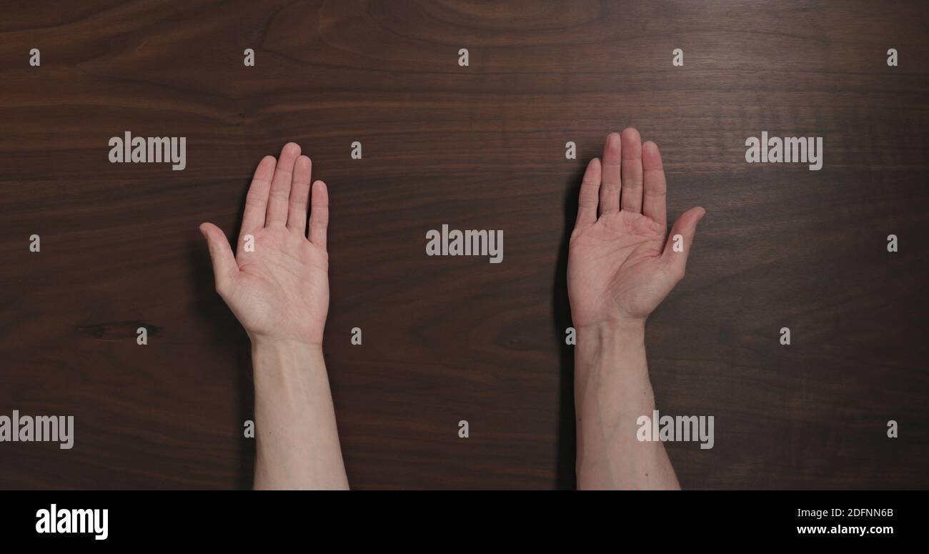 Top view man hands offer gesture black walnut table with copy space ...