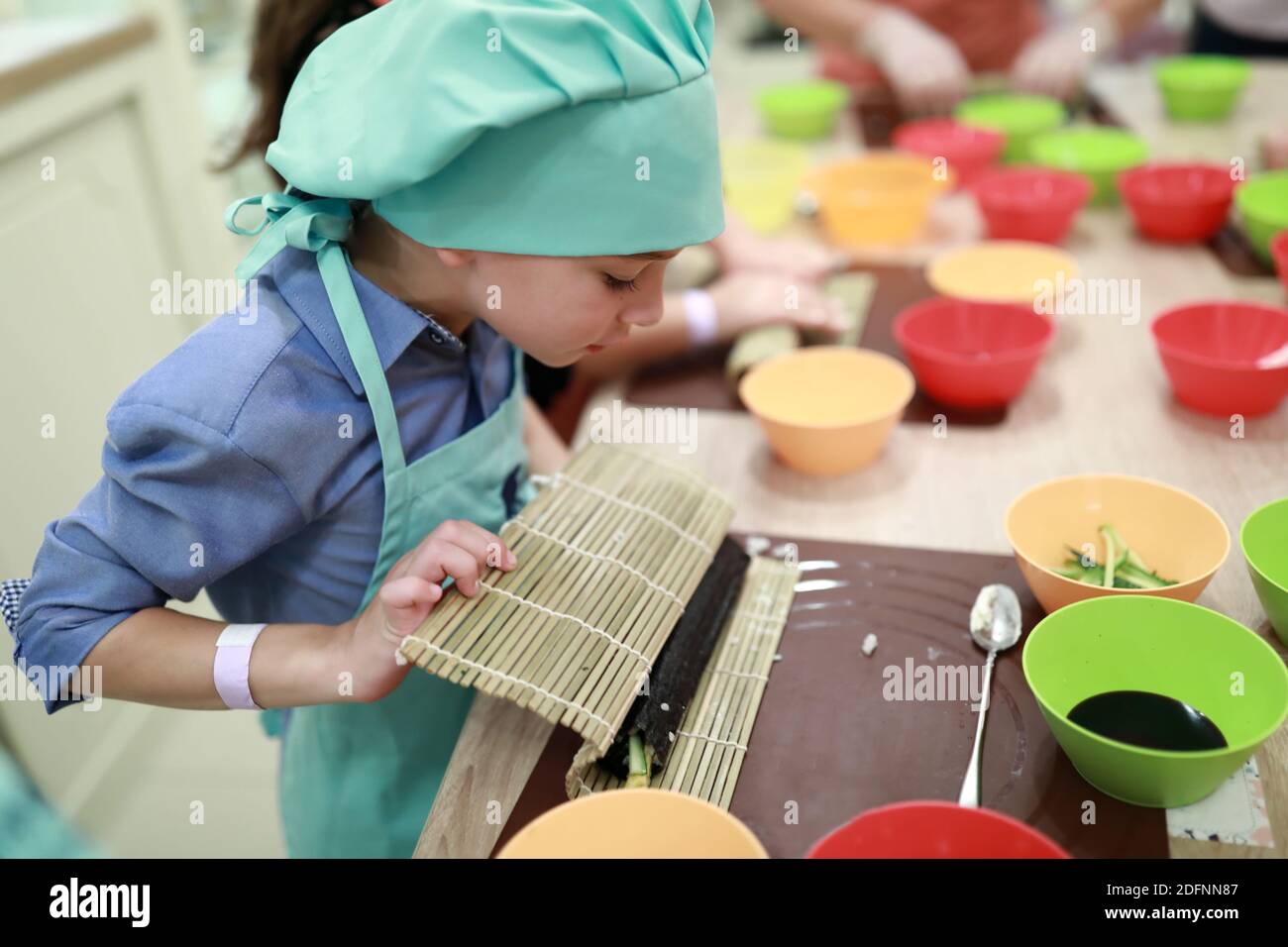 Boy preparing sushi rolls at cooking class Stock Photo - Alamy