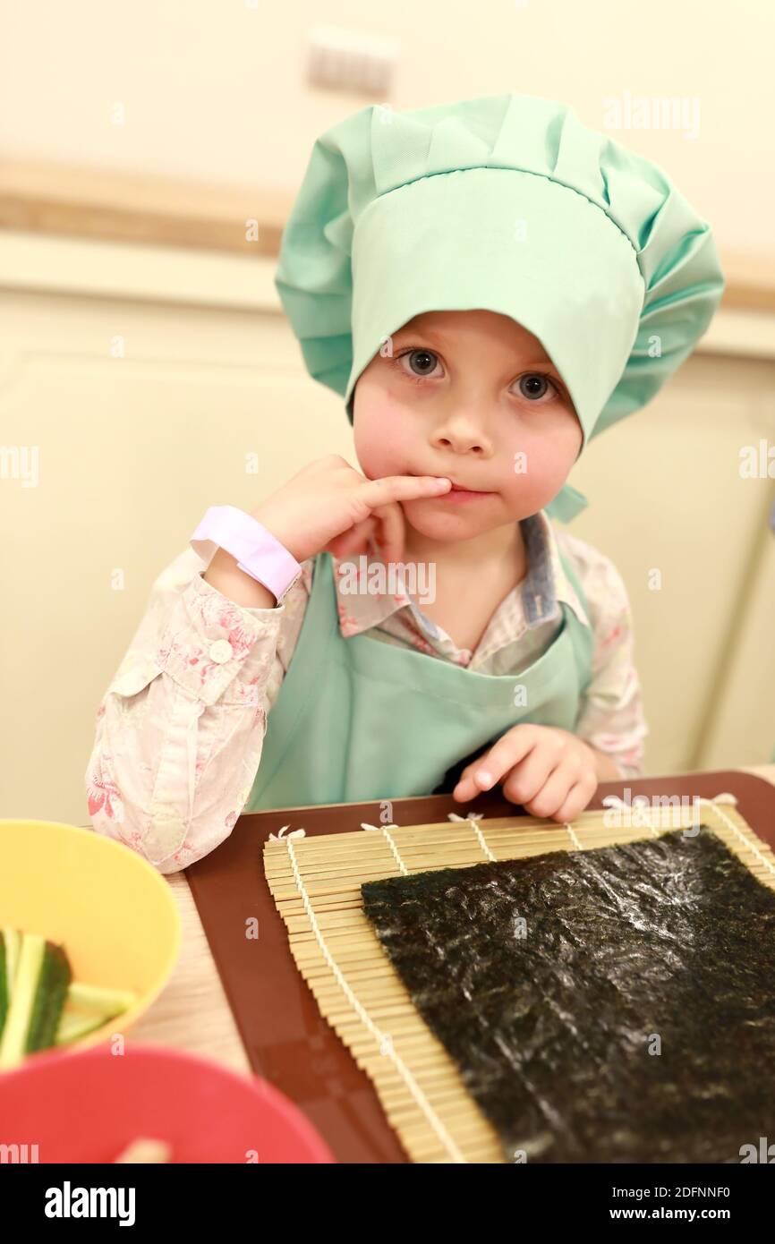 Portrait of child with nori seaweed sheet Stock Photo - Alamy