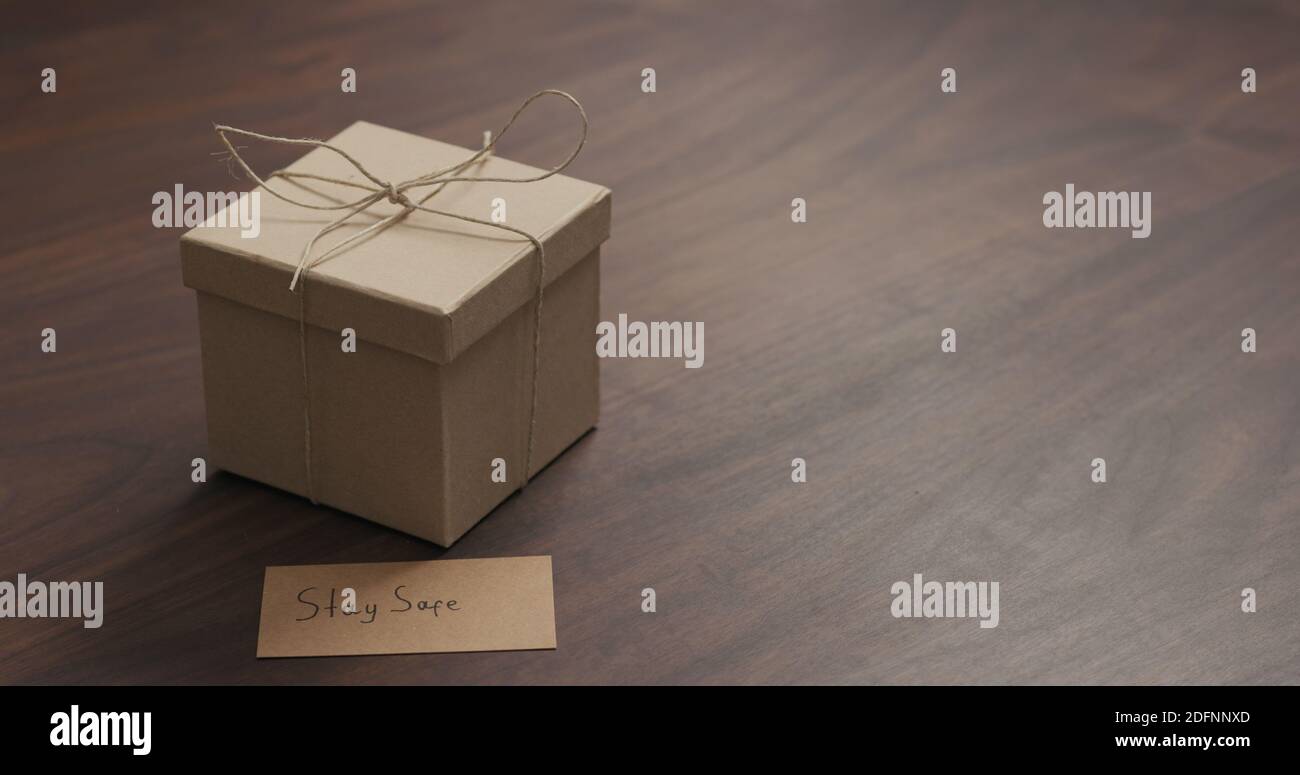 eco friendly paper gift box on walnut table with stay safe paper card ...