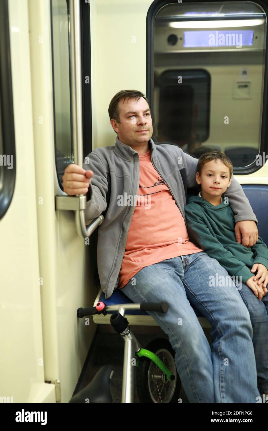 Portrait of father and his son in subway train Stock Photo - Alamy