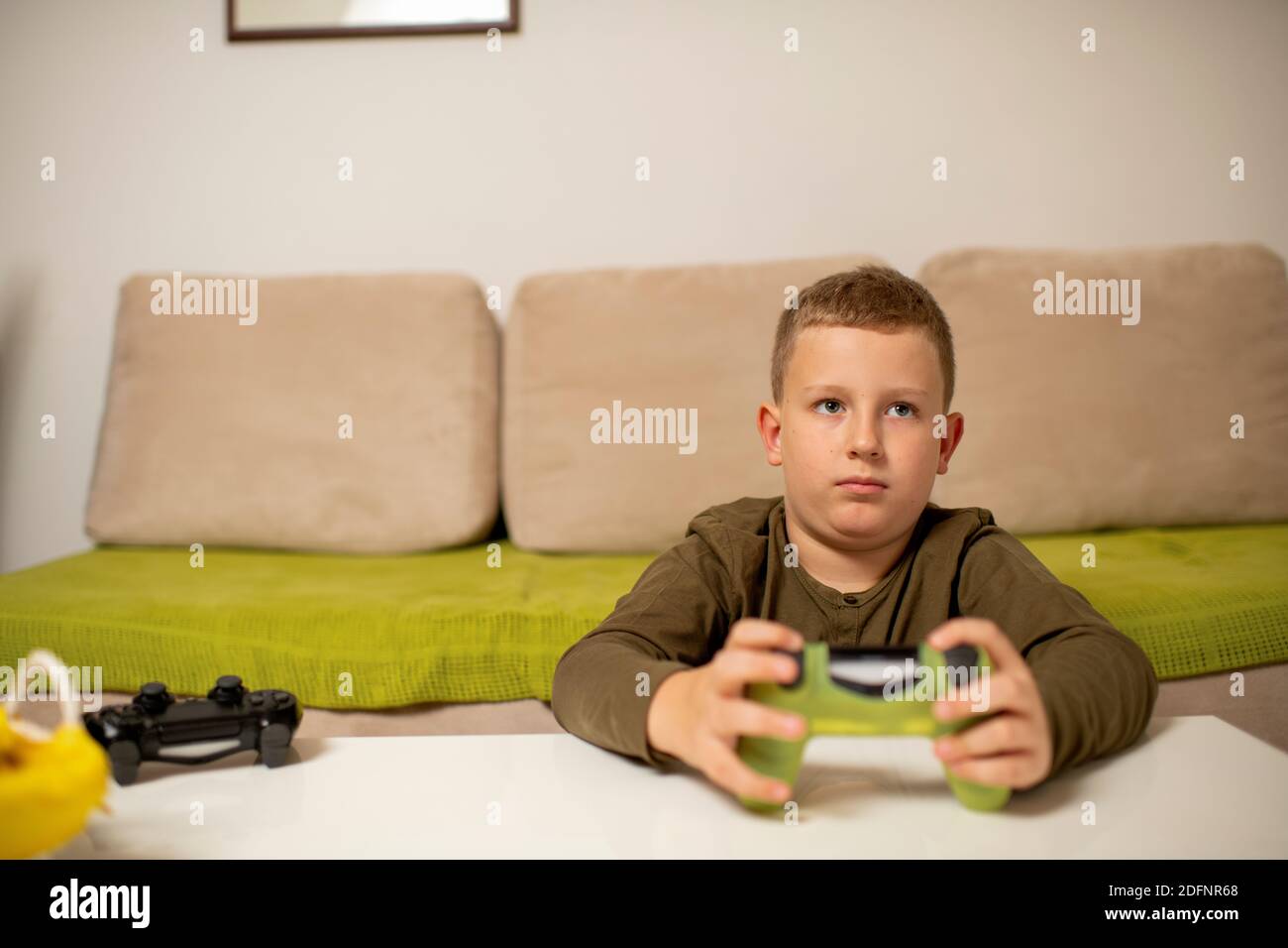 Boy playing video game console in the living room Stock Photo - Alamy