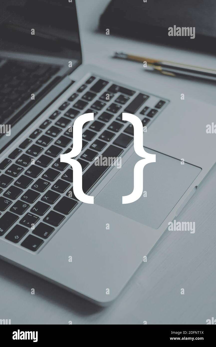 Coding and programming symbol on the background of a person typing on a ...