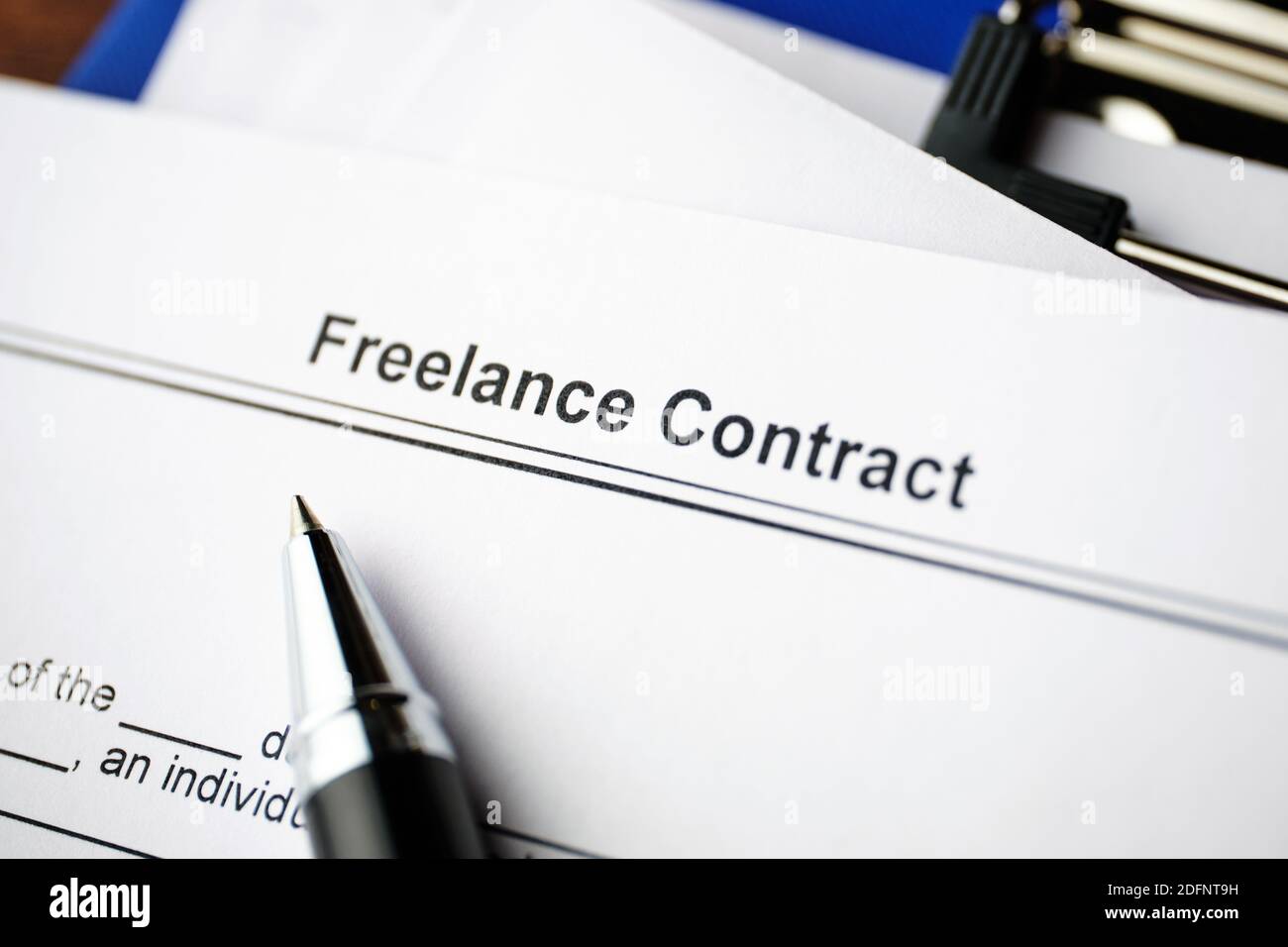 Legal document Freelance Contract on paper close up Stock Photo - Alamy