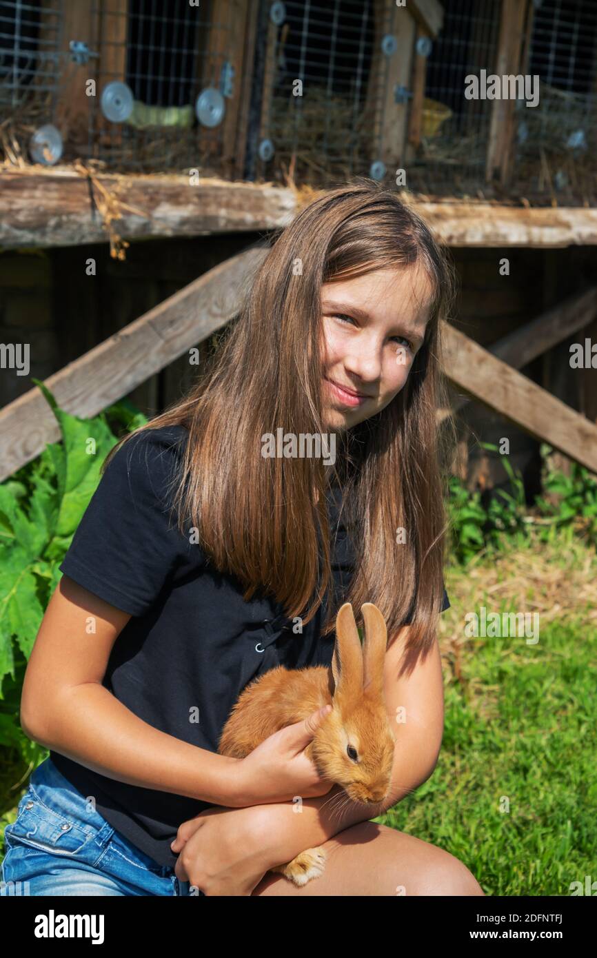 Girl with red rabbit outside Stock Photo - Alamy