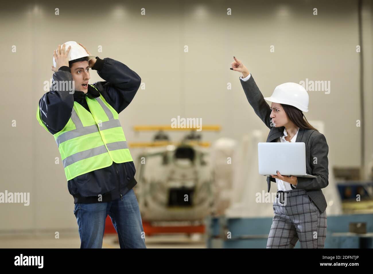 Portrait of a female factory manager in a white hard hat and business ...