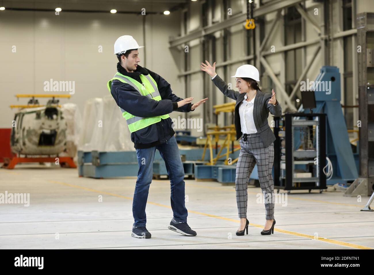 Portrait of a female factory manager in a white hard hat and business ...