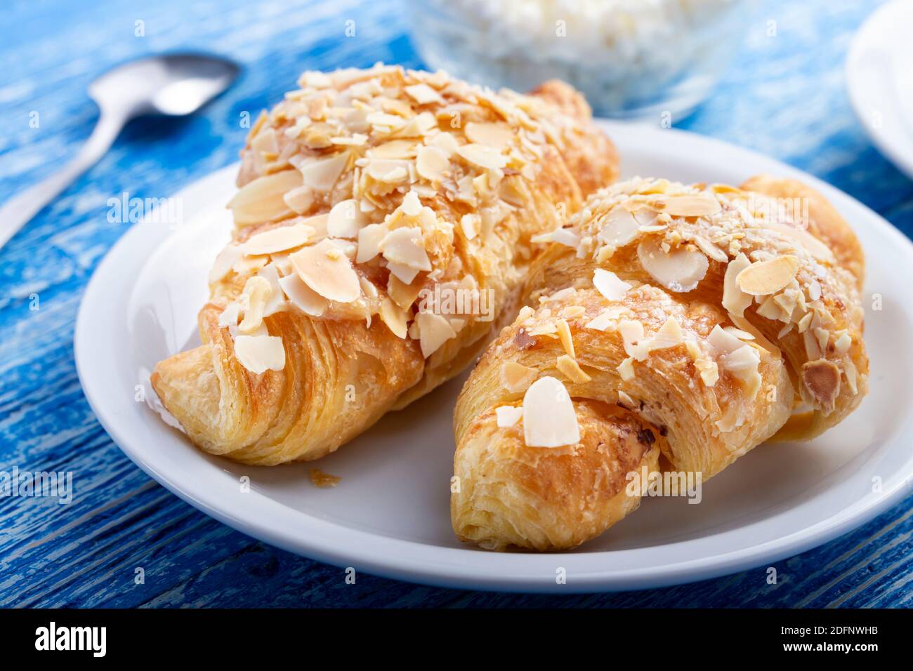 Morning breakfast. Fresh French croissant in a plate on a blue wood ...