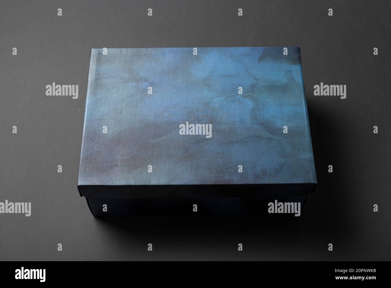 Shoe box in blue on a gray background. Side view Stock Photo - Alamy