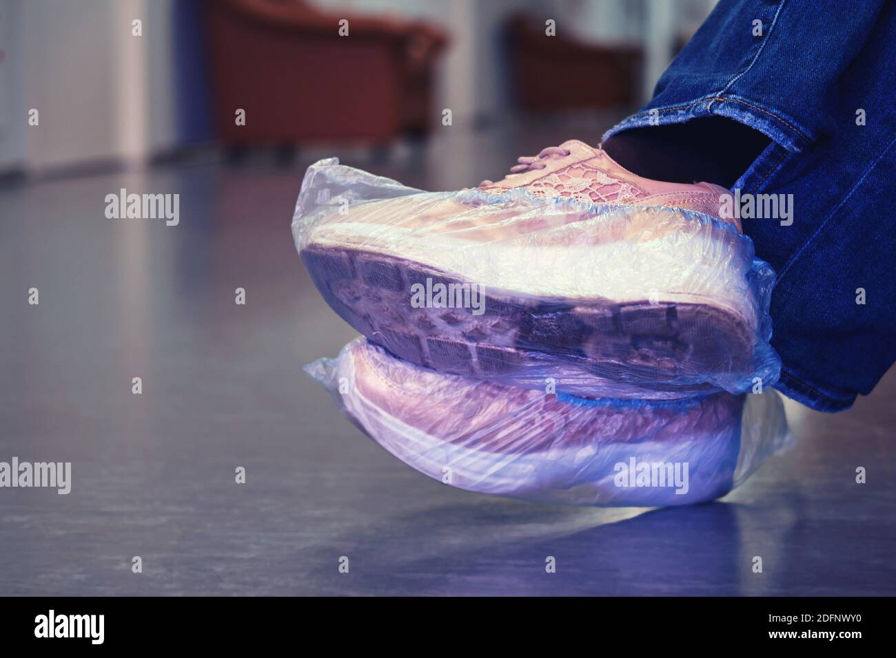 Shoes in shoe covers on a woman leg in a hospital Stock Photo - Alamy