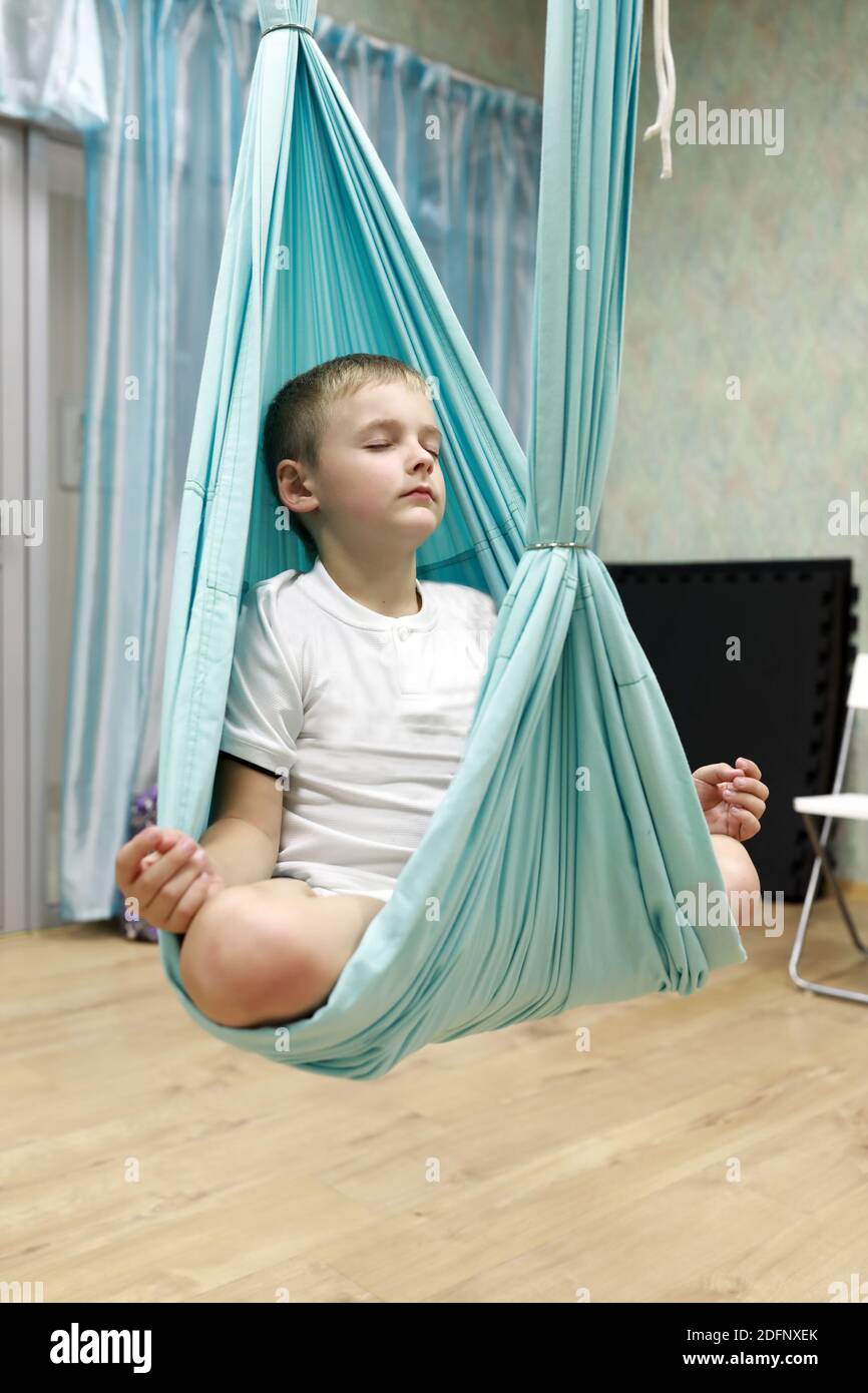 Child practices aerial yoga in a gym Stock Photo - Alamy