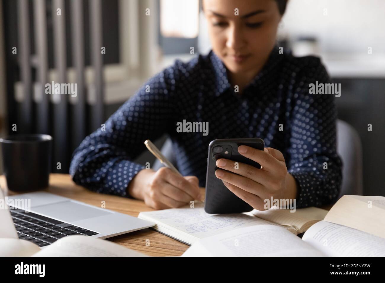 Focused indian female write up information from phone screen Stock ...