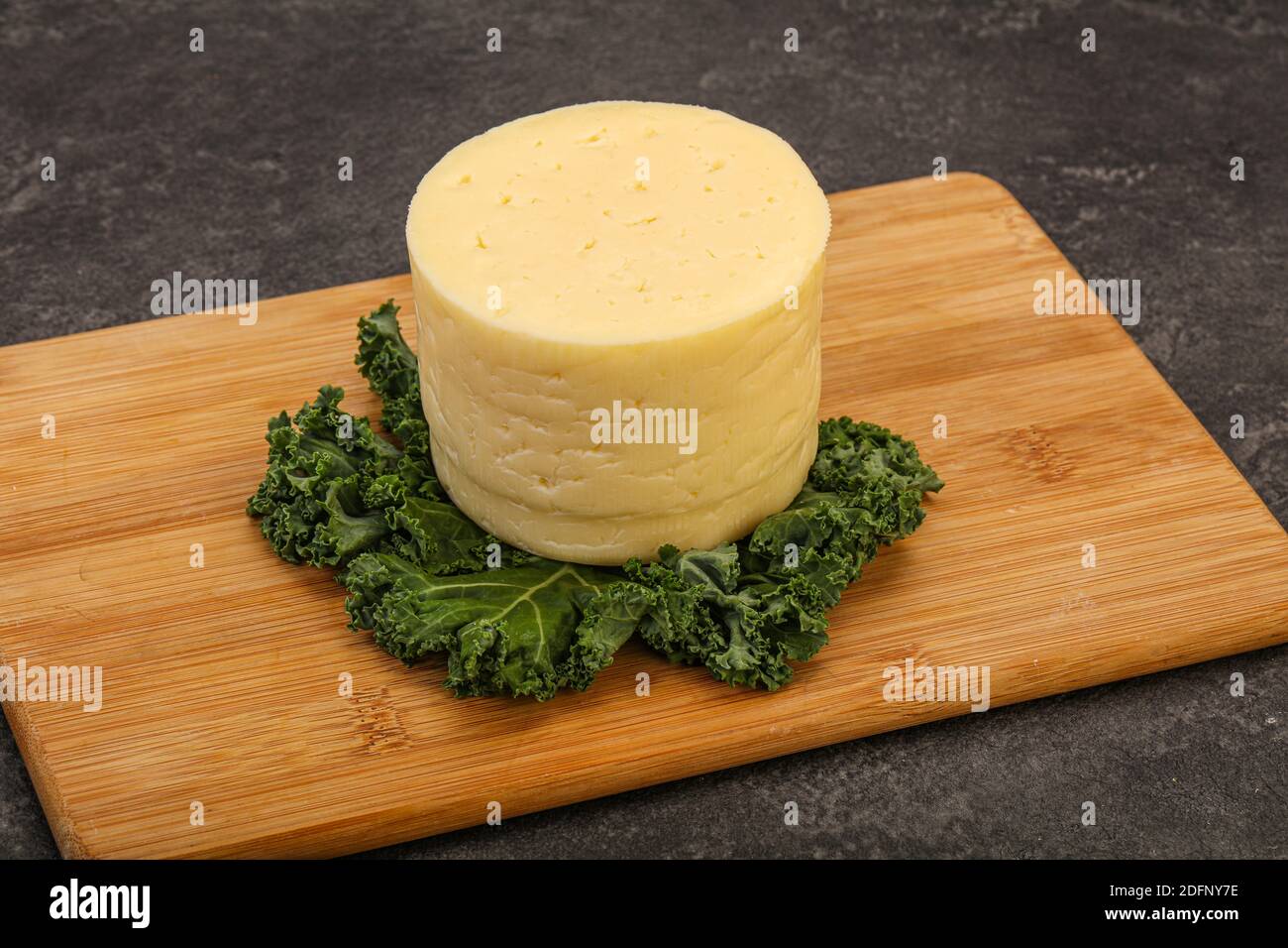 Yellow round dairy soft cheese piece Stock Photo - Alamy