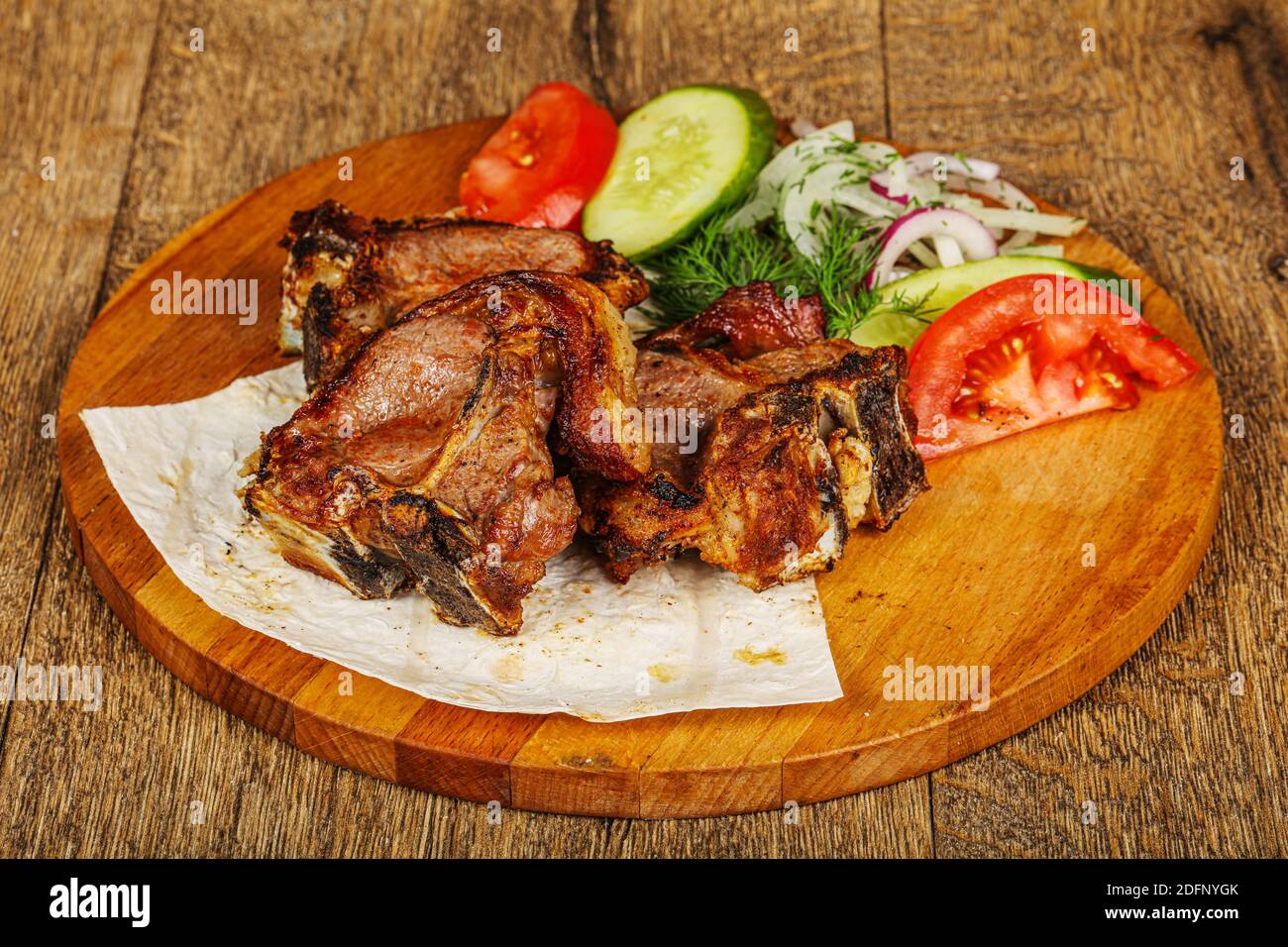 Grilled lamb barbeque served vegetables and onion Stock Photo - Alamy