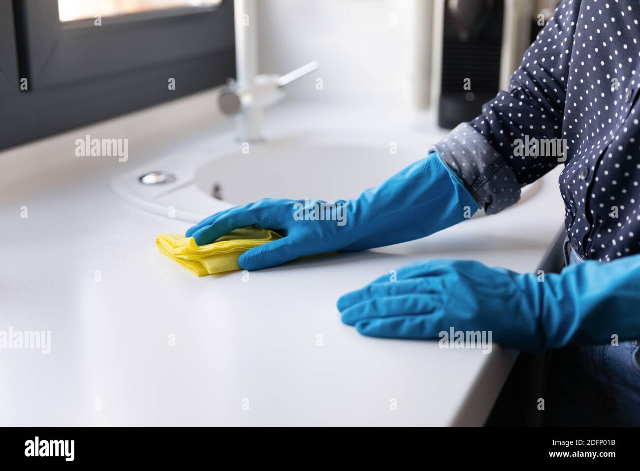 Female hands in rubber gloves cleaning kitchen counter with rag Stock ...