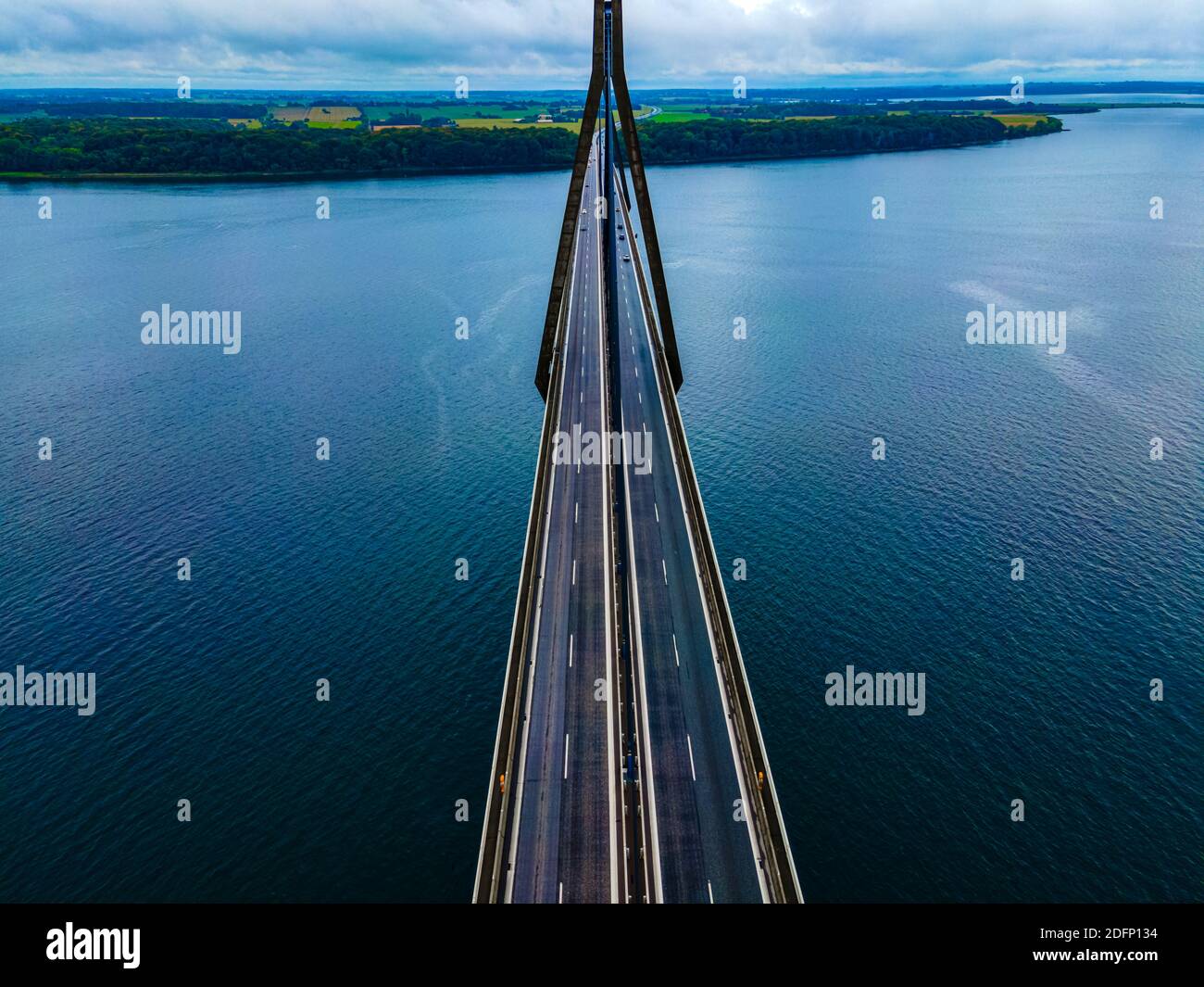 Large highway bridge spanning over a bay, with cars and trucks driving ...