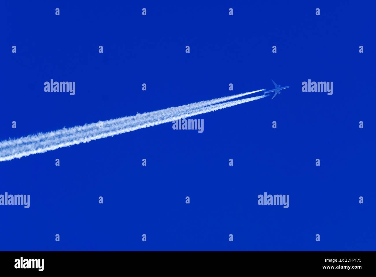 2 engine passenger jet aicraft at altitude travelling diagonally left ...