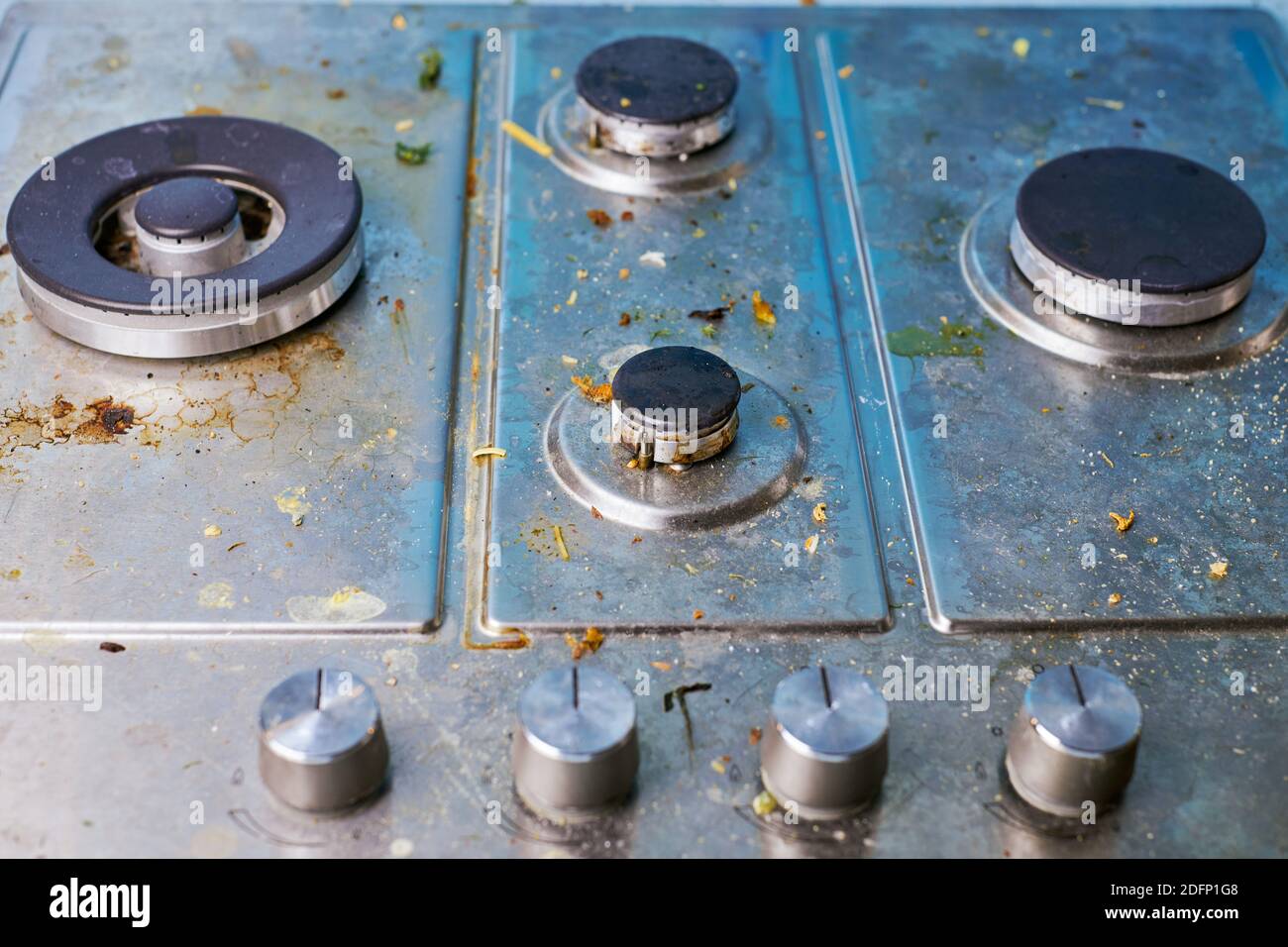 Dirty gas stove top with food leftovers. Unclean steel kitchen cooktop ...
