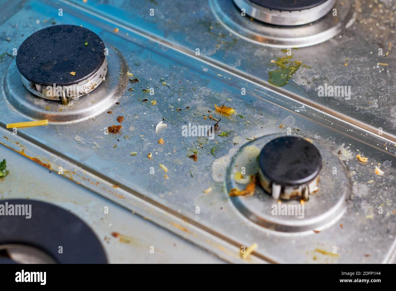 Dirty gas stove top with food leftovers. Unclean steel kitchen cooktop ...