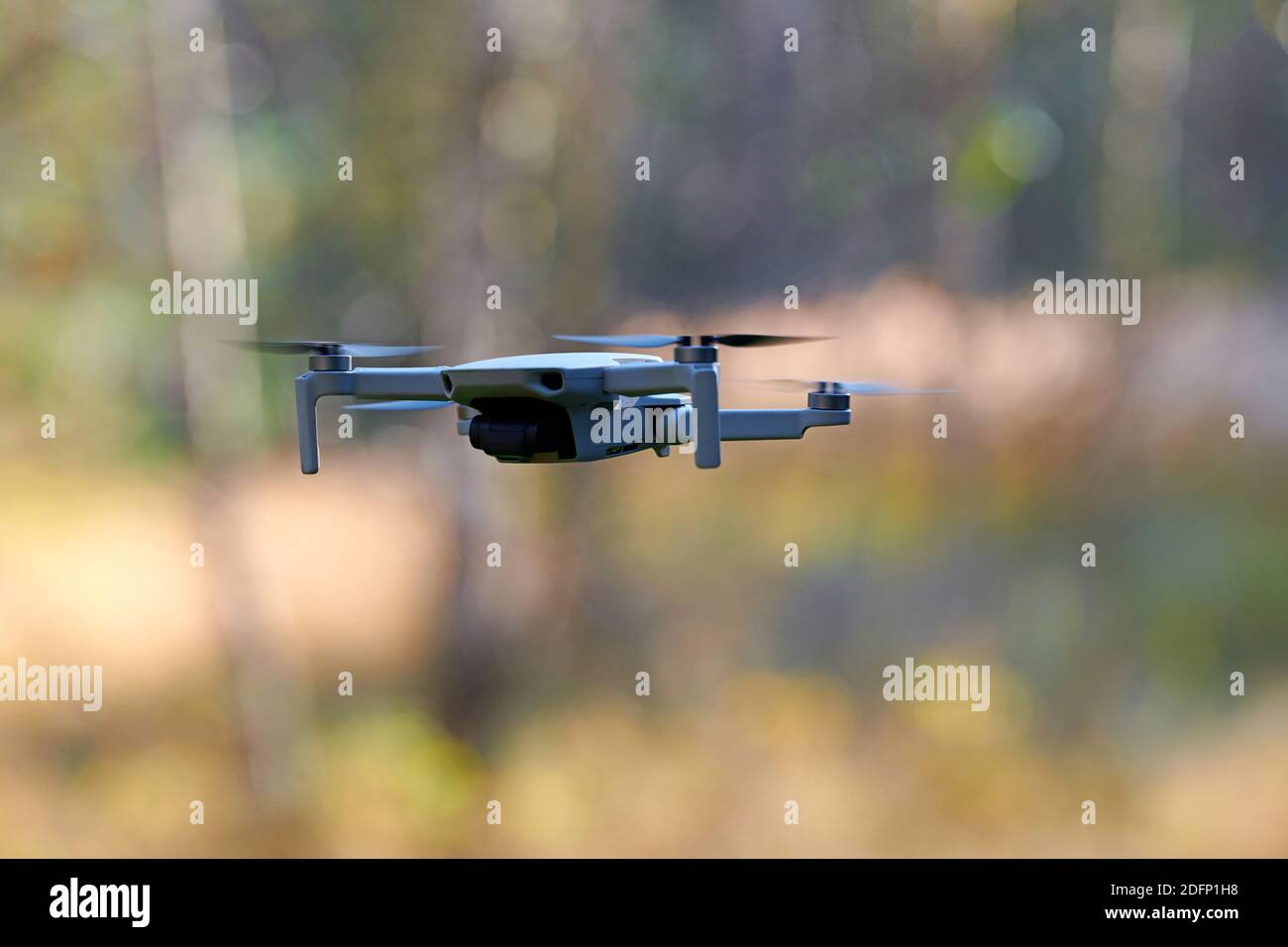 Quadcopter drone in sky. Small drone flies in sky taking video and ...