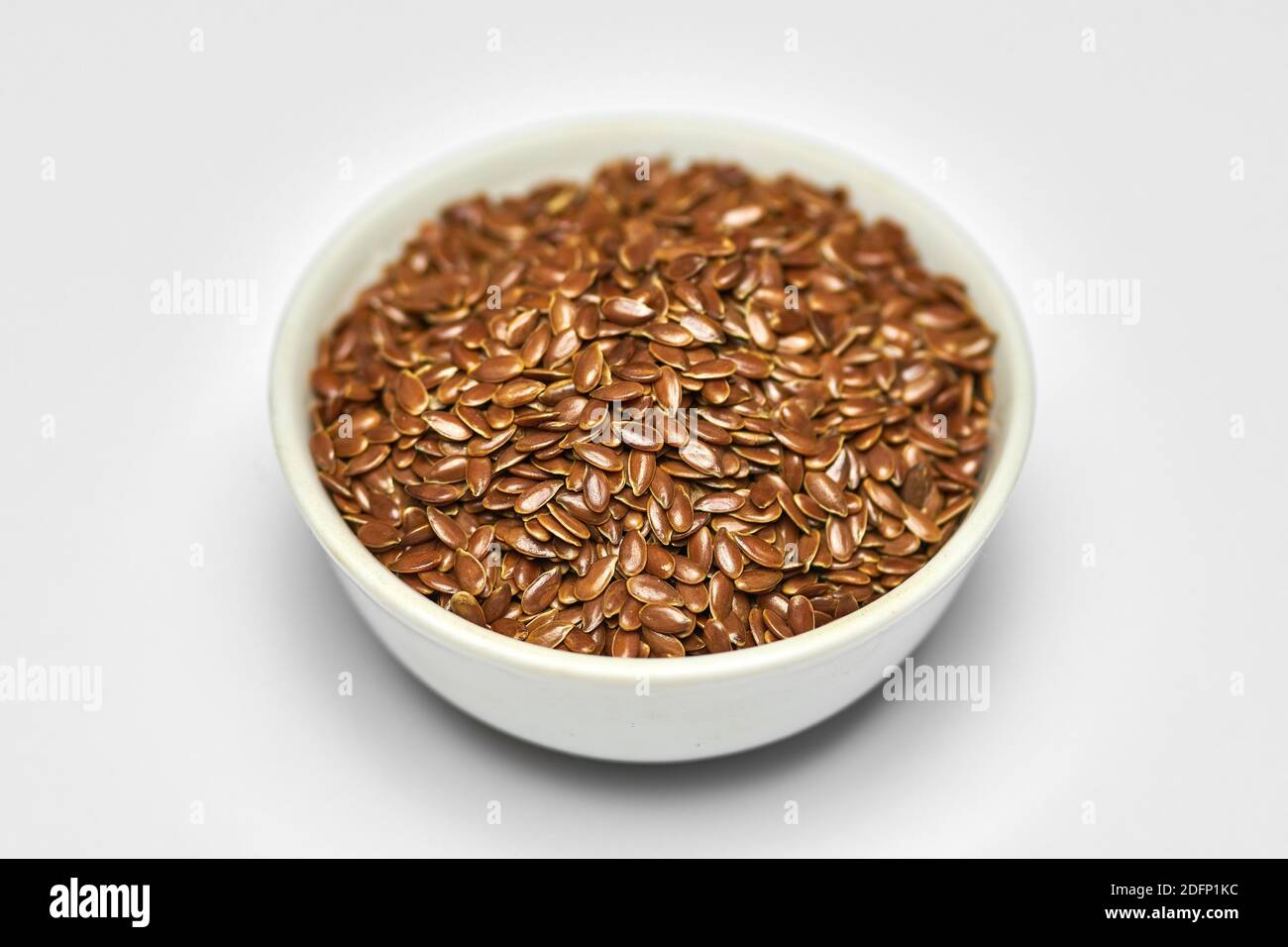 Flaxseed, linseed in bowl, isolated. Bunch of Linum usitatissimum ...