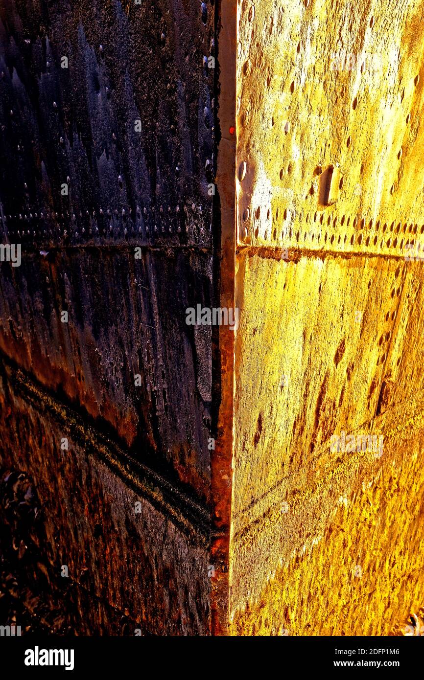 Rusting steel plates on an old ships hull at sunset Stock Photo - Alamy