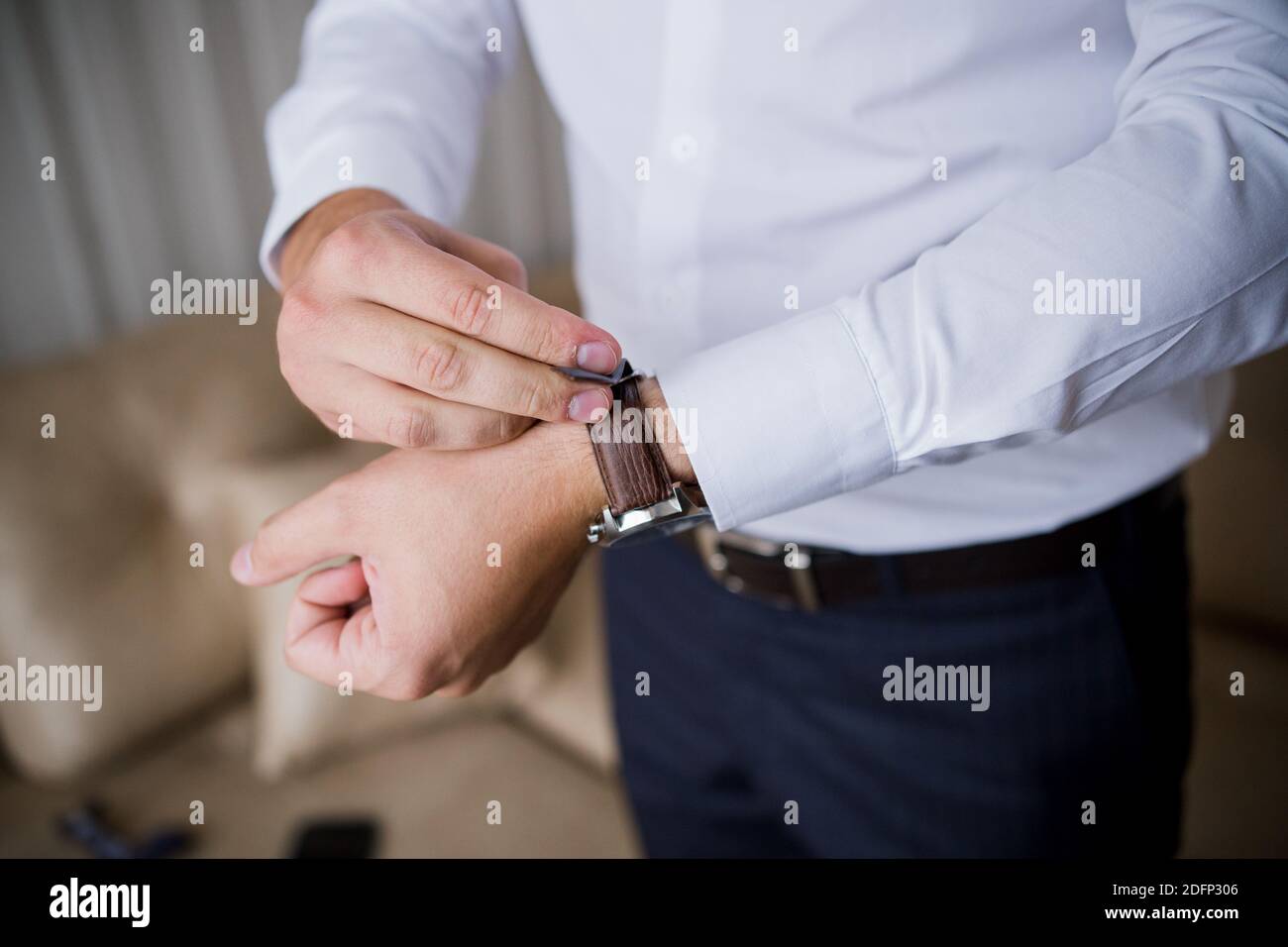 man puts a classic watch on his hand Stock Photo - Alamy