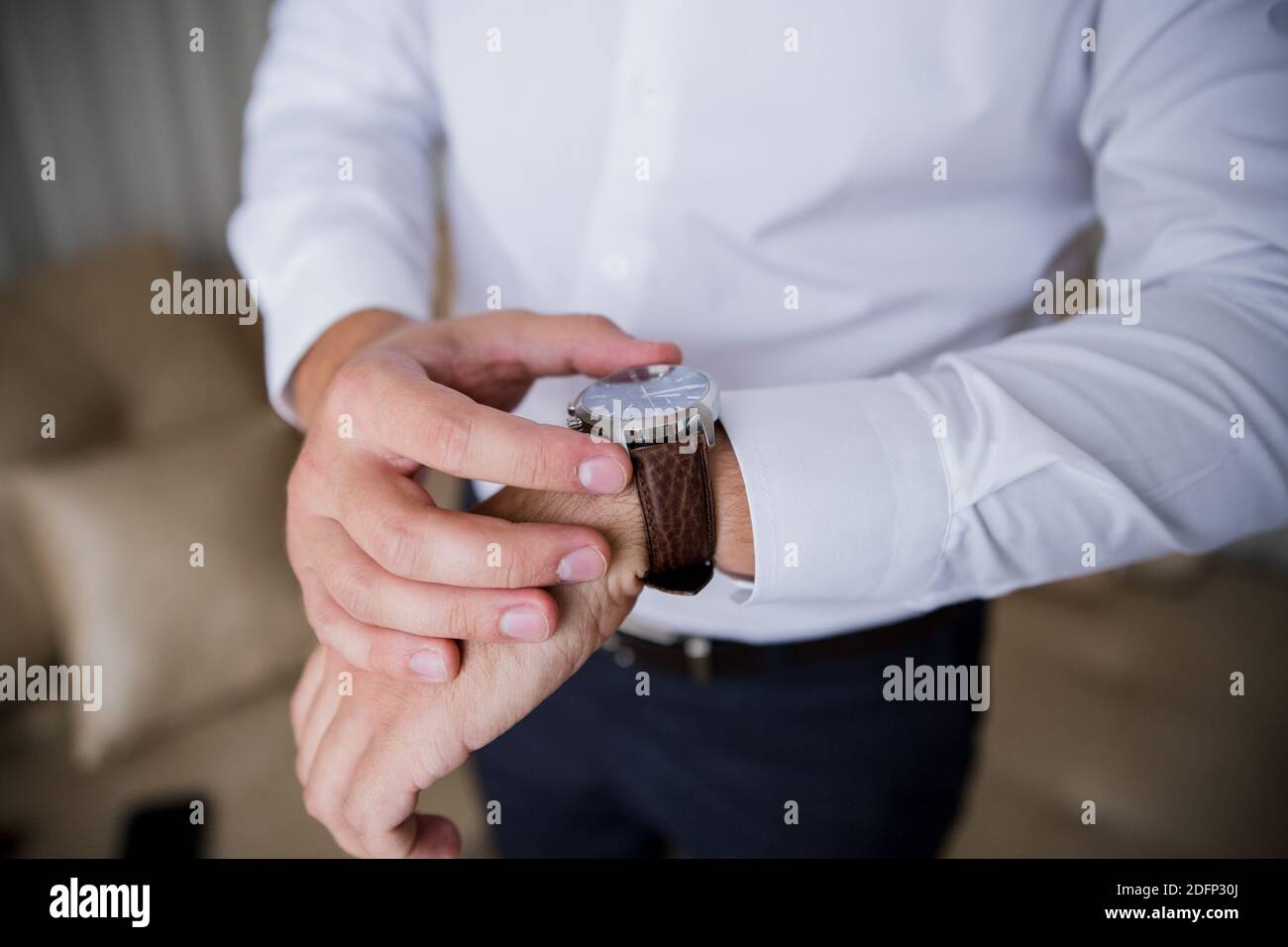 man puts a classic watch on his hand Stock Photo - Alamy