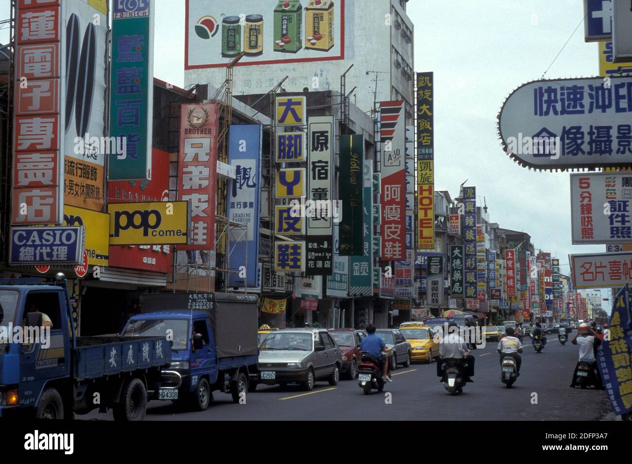 a road with neon signs and Shops in the city centre of Taipei in Taiwan ...
