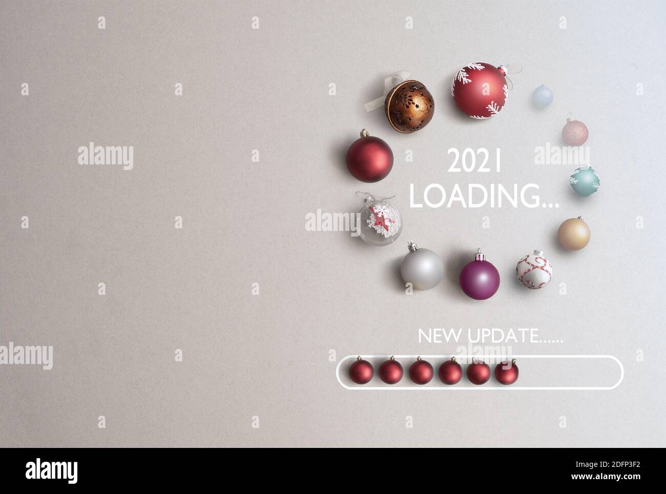 Baubles in the shape of a page loading icon with 2021 in the centre and ...