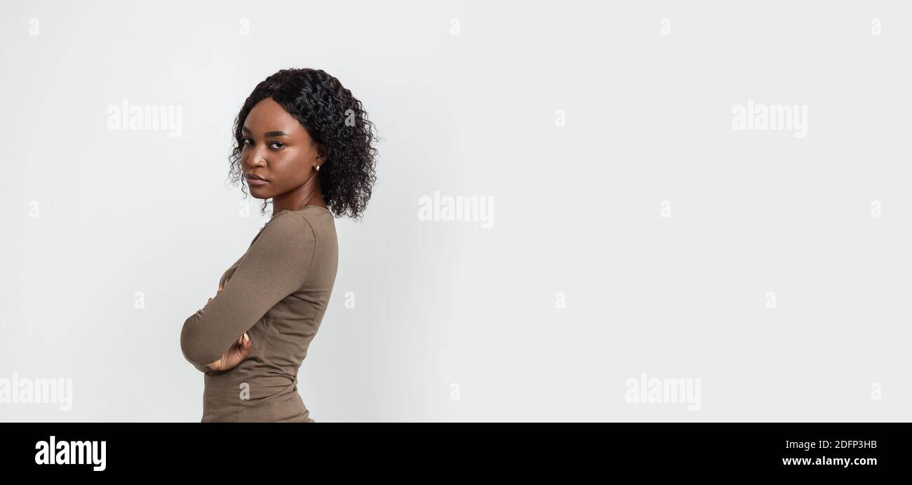 Upset black woman with arms crossed on grey Stock Photo - Alamy